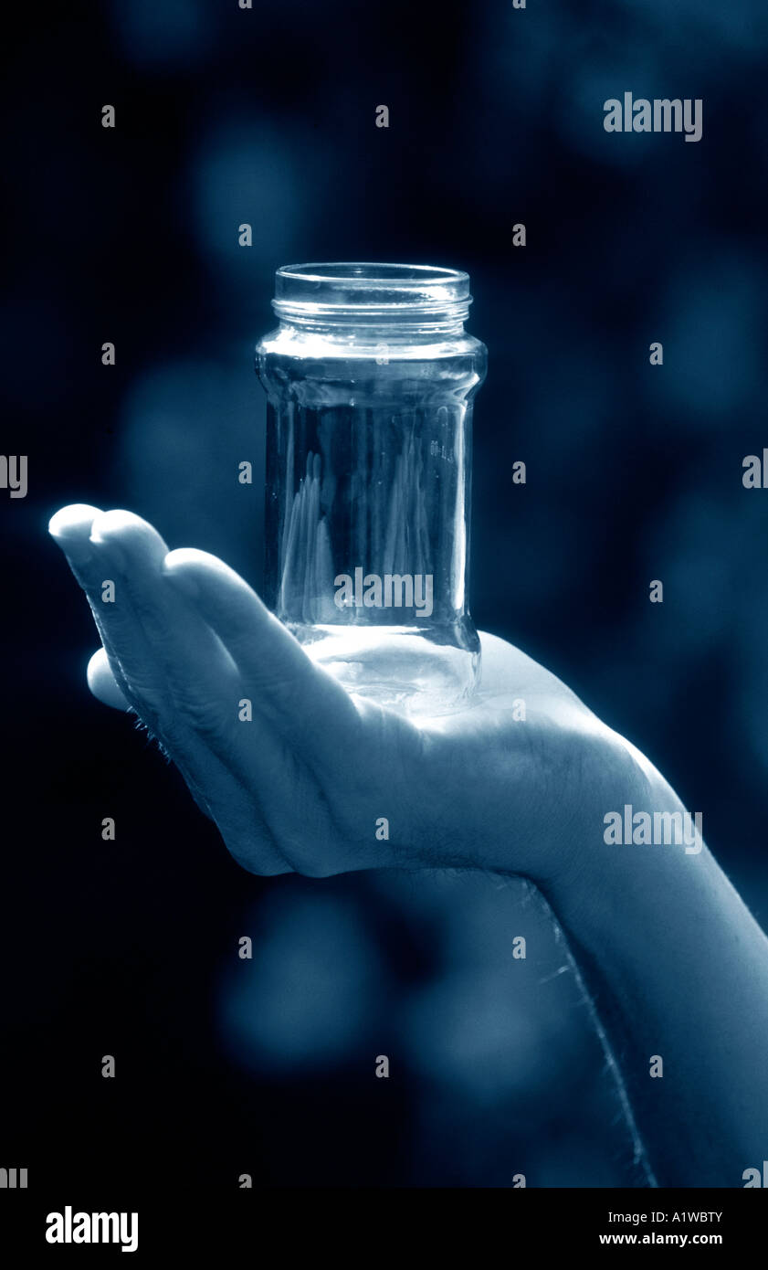 Mans Hand Holding An Empty Glass Jar ,Outside In The Daylight Stock ...