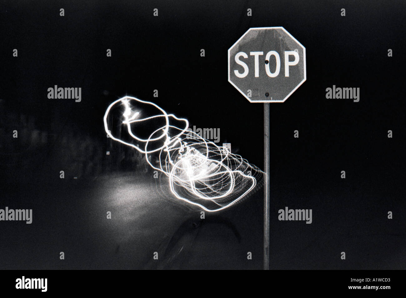 night shot of stop sign with dragged shutter effect Stock Photo - Alamy