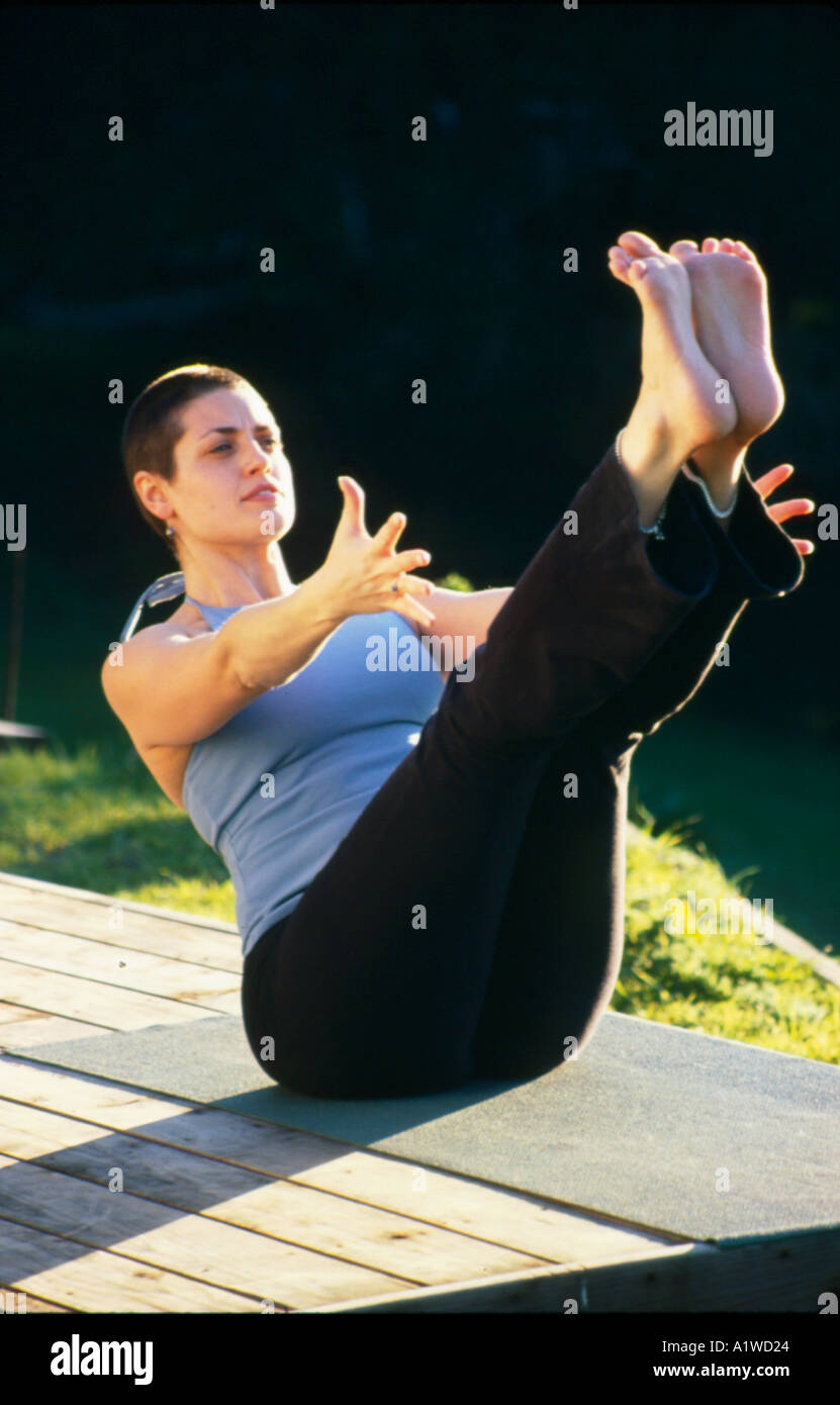 yoga poses by female yoga instructor Stock Photo - Alamy