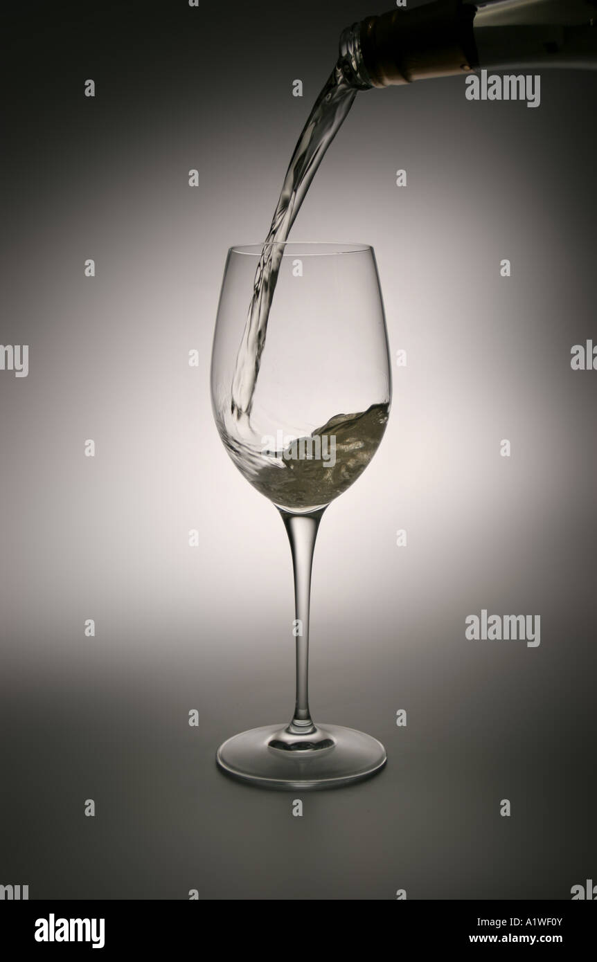 White wine being poured Stock Photo - Alamy