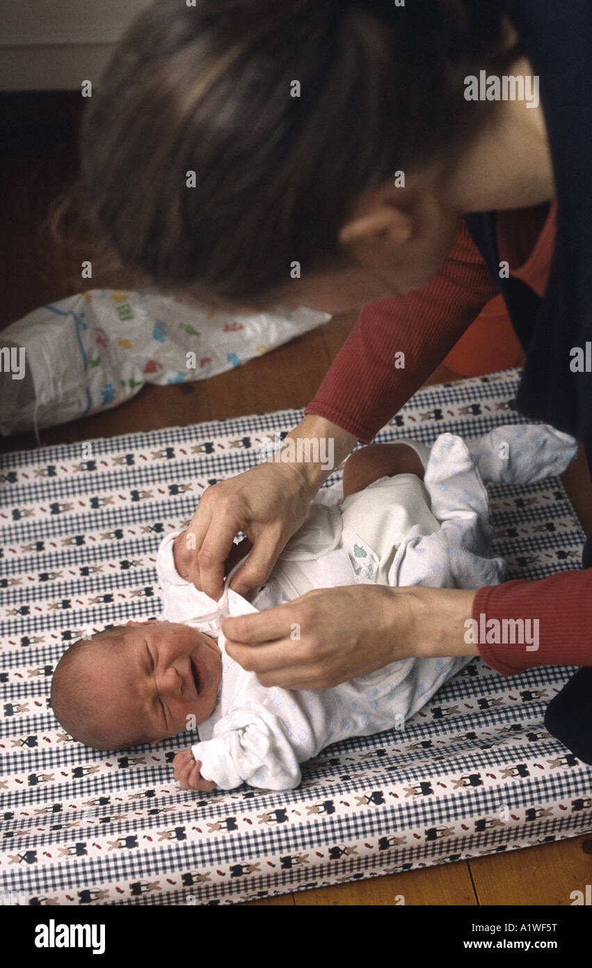 mother dressing newborn baby Stock Photo - Alamy