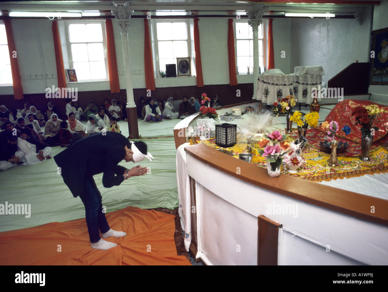 Inside a Sikh Temple with worshippers Stock Photo - Alamy