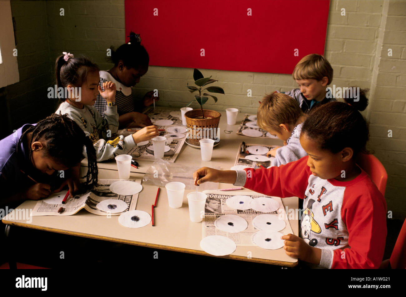 PRIMARY SCHOOL SCIENCE CLASS.Children do experiments on their table ...