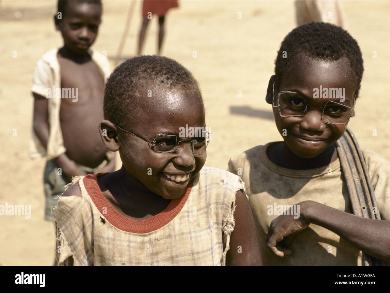 ANGOLA CHILDREN PLAYING including two boys wearing home-made wire ...