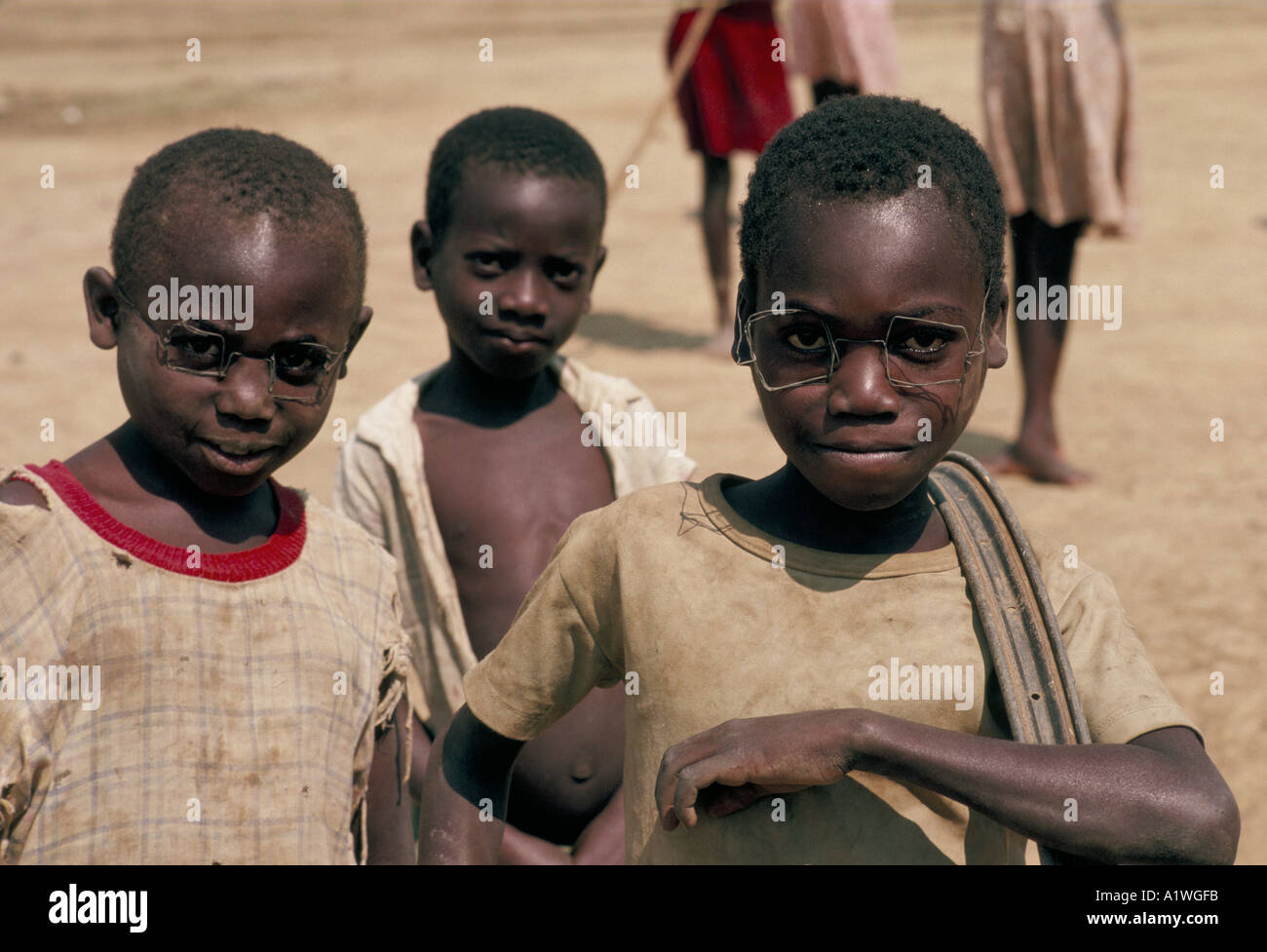 ANGOLA CHILDREN PLAYING including two boys wearing home-made wire ...