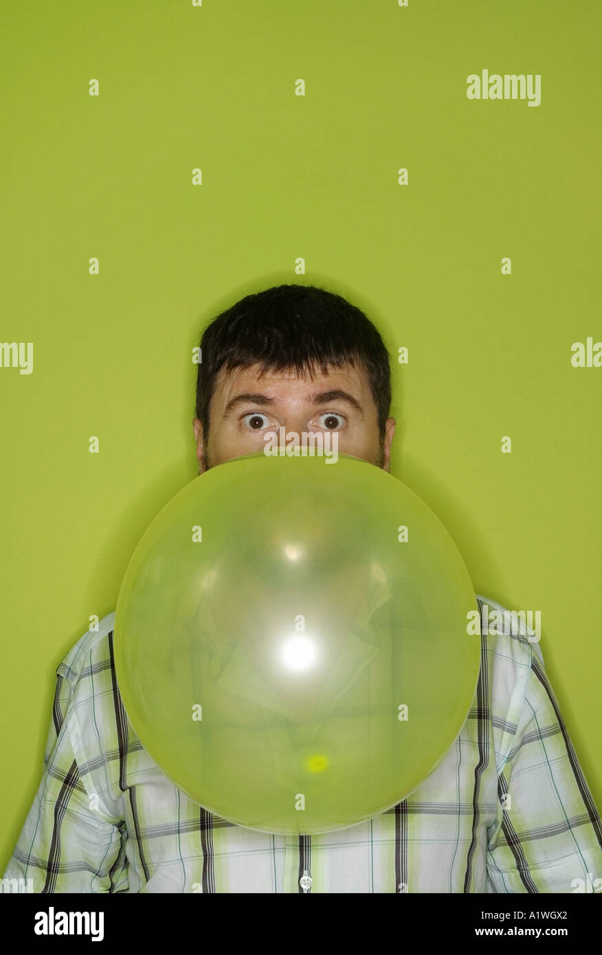 MAN INFLATING BALLOON Stock Photo - Alamy