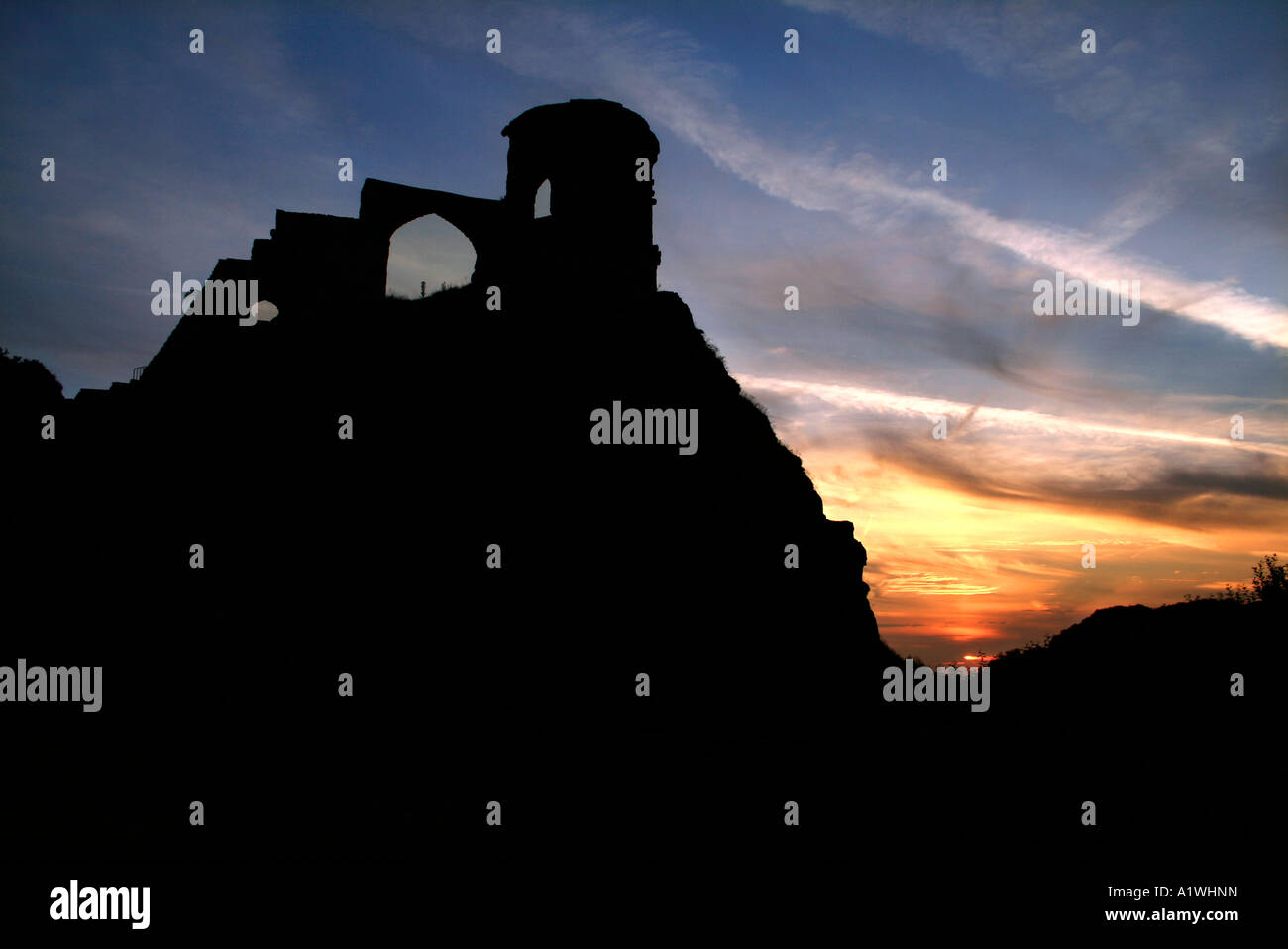Sunset and silhouette of Mow Cop, a folly south of Congleton, Cheshire ...