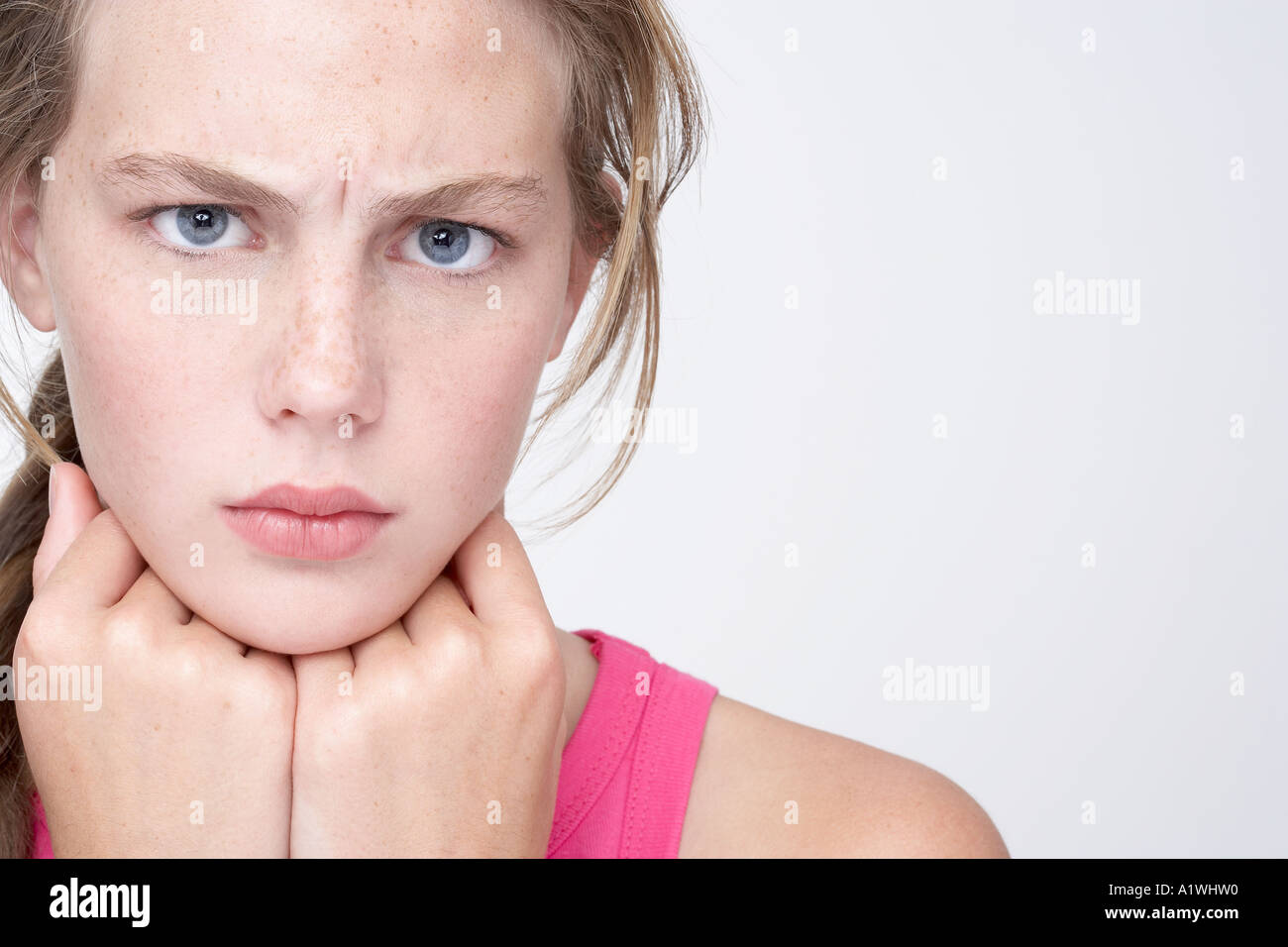 Portrait of a young woman looking angry Stock Photo - Alamy
