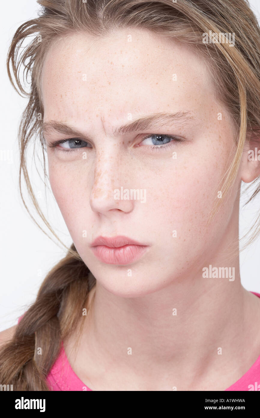Portrait of a young woman looking angry Stock Photo - Alamy