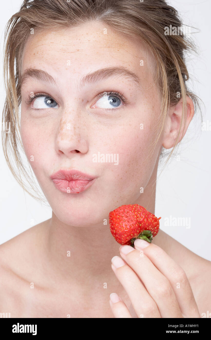 Woman licking strawberry hi-res stock photography and images - Alamy