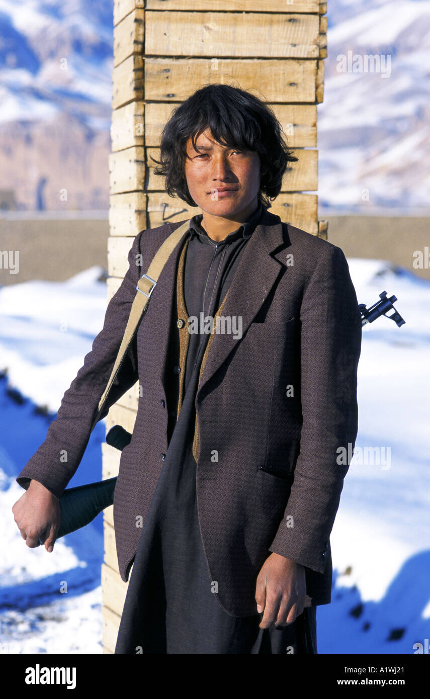 BAMIYAN AFGHANISTAN .Young boy guard with kalashnikov by sentry box in ...