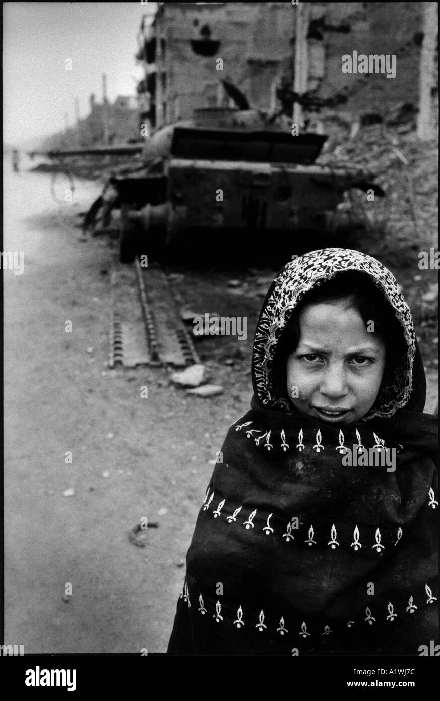 AFGHANISTAN KABUL 1996 YOUNG GIRL STANDING NEXT TO A TANK IN THE TOWN ...