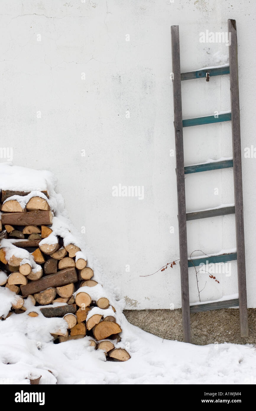 Snowy firewood, wooden ladder Stock Photo - Alamy