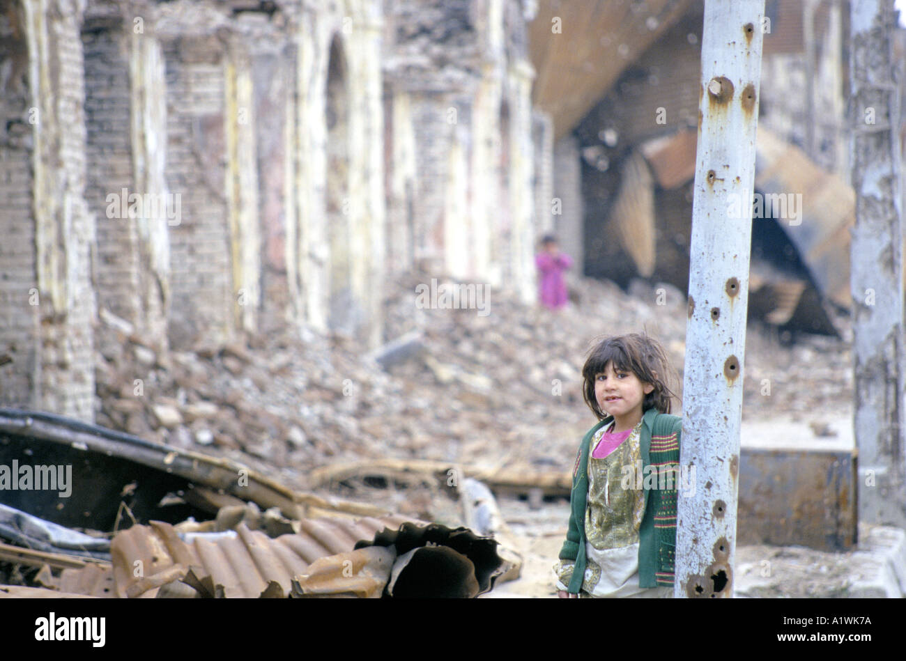 Young girl walking by mined buildings KABUL 1996 Stock Photo - Alamy