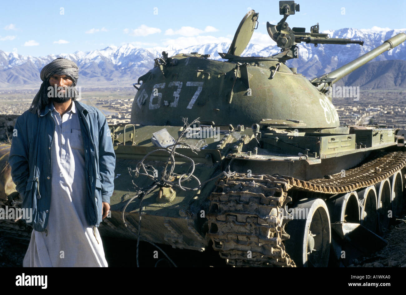 KABUL AFGHANISTAN 1996. Man standing next to tank, overlooking the city ...