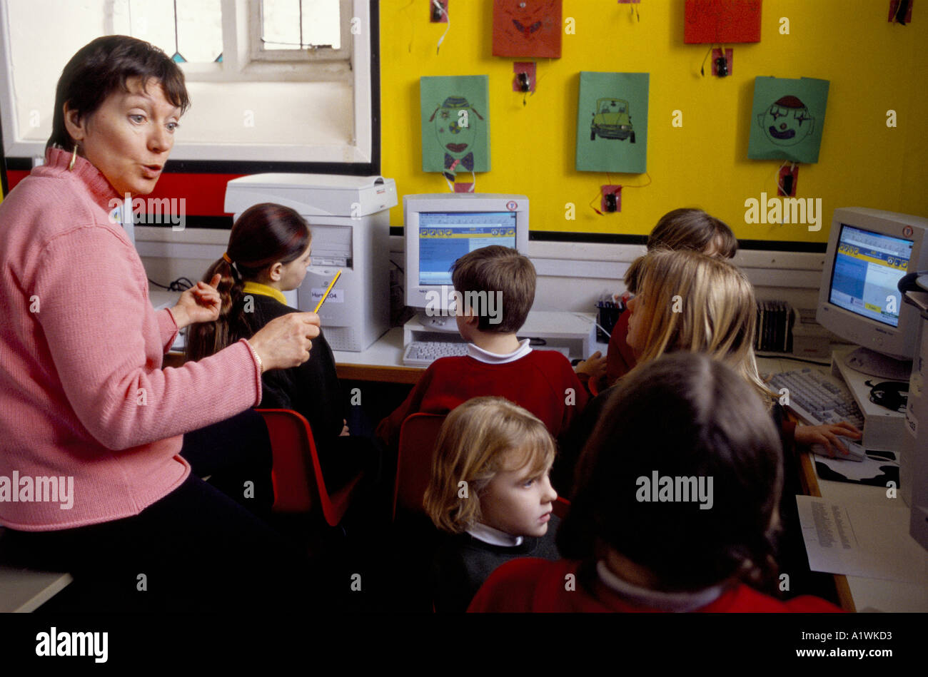 SMALL RURAL COMPUTER CLASS 2001.Teacher with group of young children ...