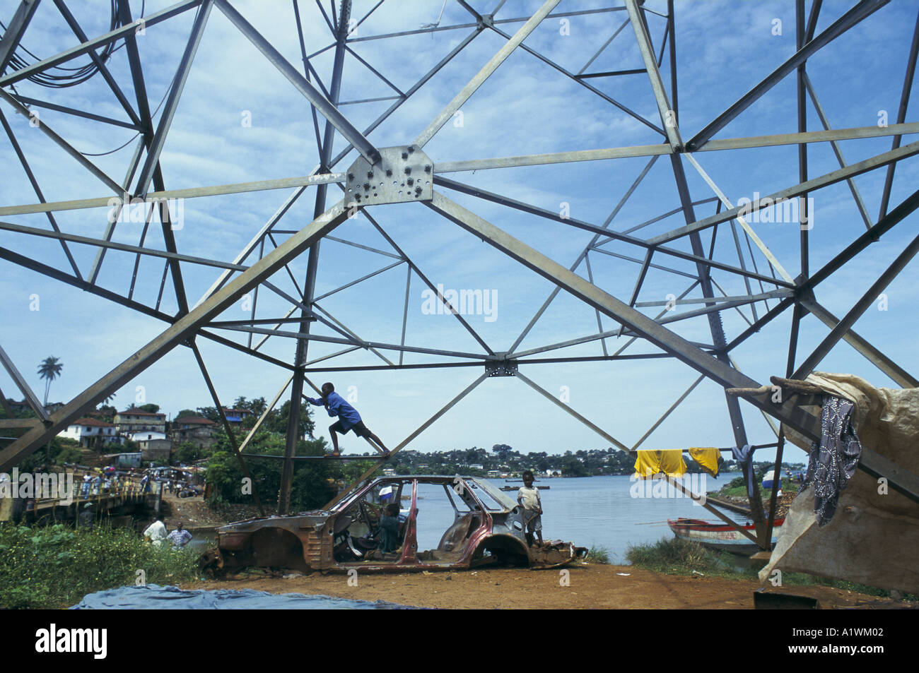 CHILDREN PLAYING ON PYLONS AND BURNT OUT CAR IN CONGO TOWN 1999 Stock ...