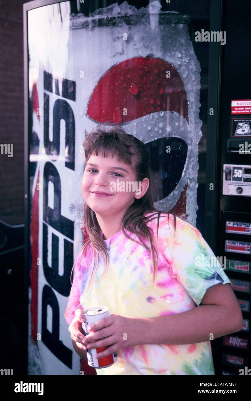 Young woman standing next to Pepsi Cola DRINK VENDING MACHINE, and ...