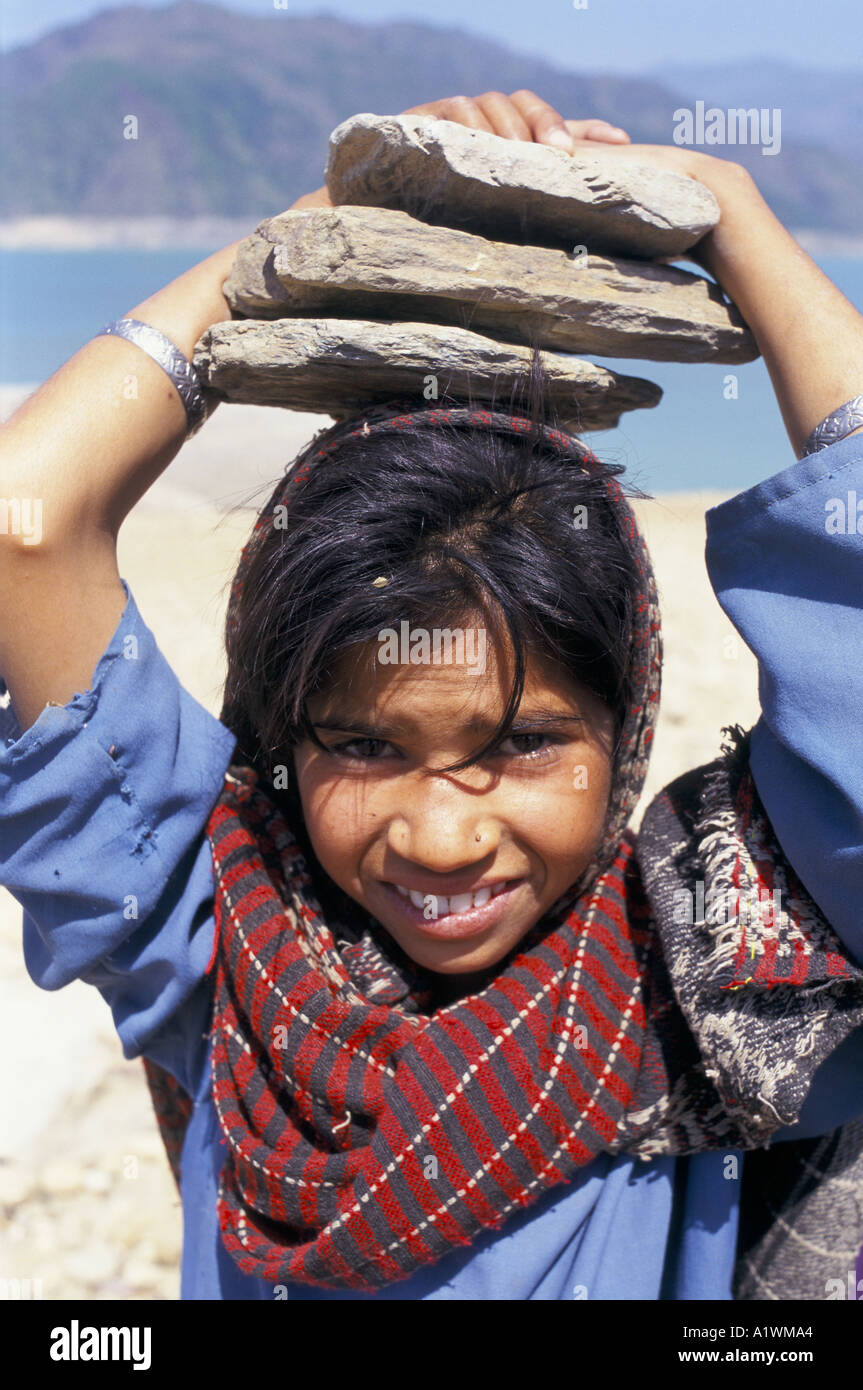 YOUNG GIRL COLLECTING BUILDING STONES PAKISTAN 1998 Stock Photo - Alamy