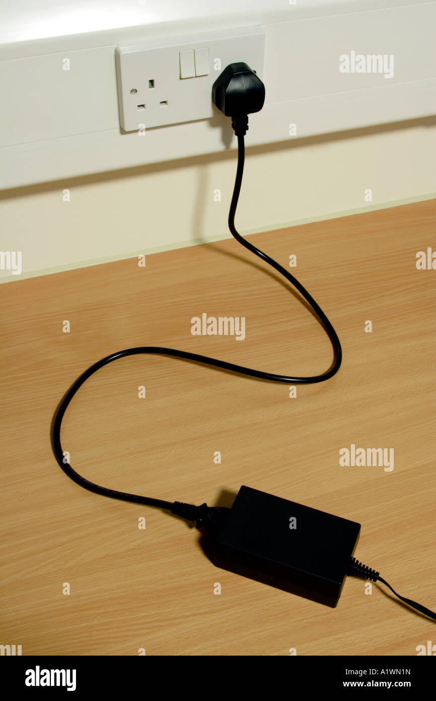 Power cord plugged into mains socket Stock Photo - Alamy