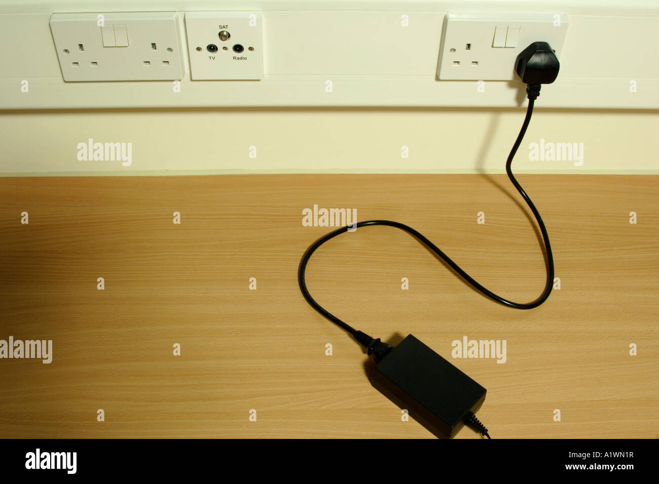 Power cord plugged into mains socket Stock Photo - Alamy