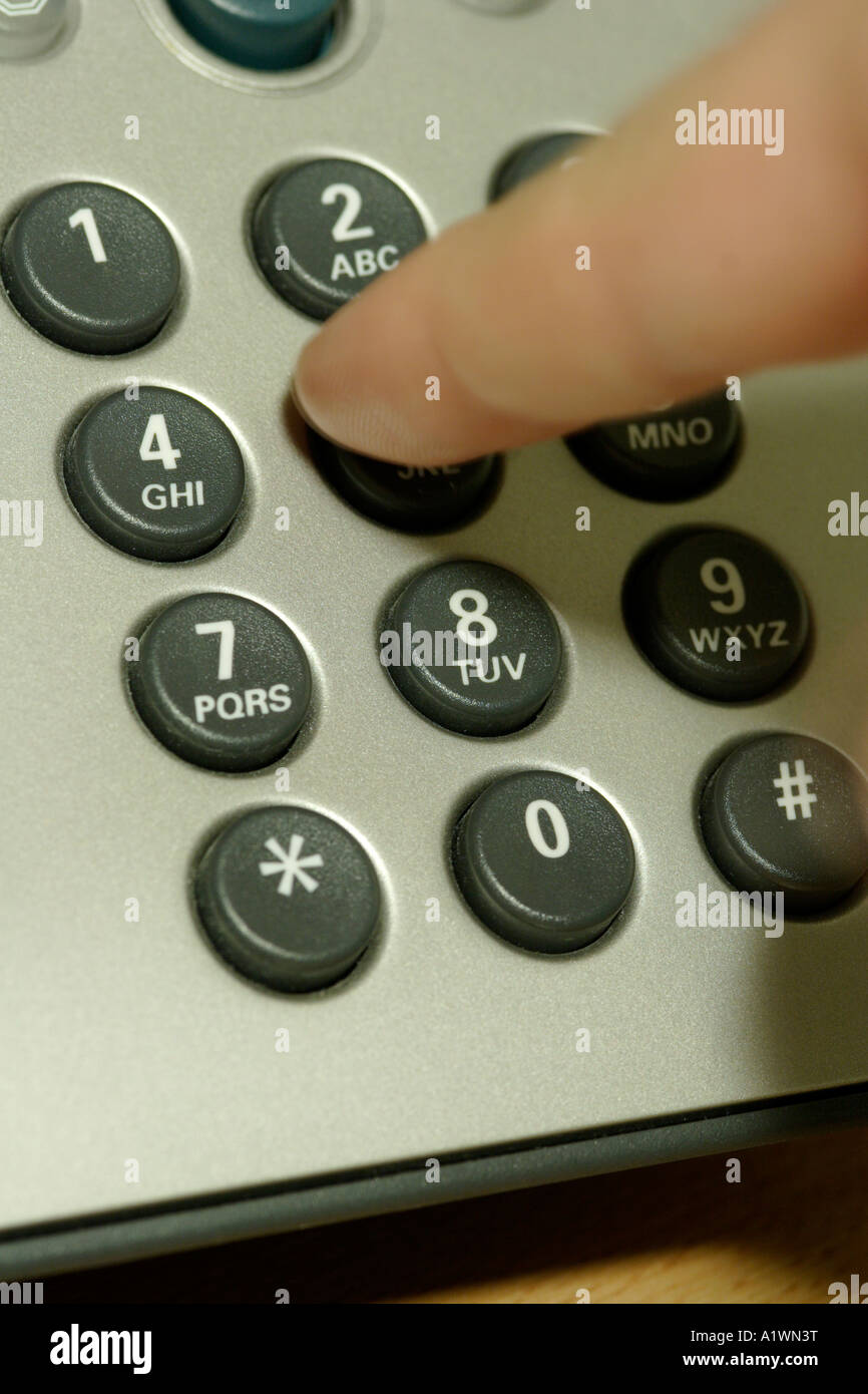 Person dialing phone keypad Stock Photo - Alamy