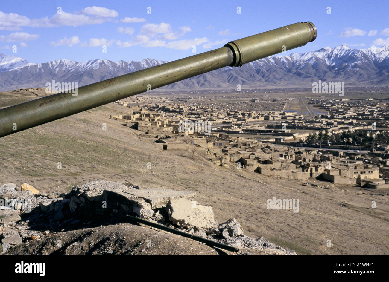 Aerial VIEW OF THE CITY OF KABUL, with tank turret framing the view ...