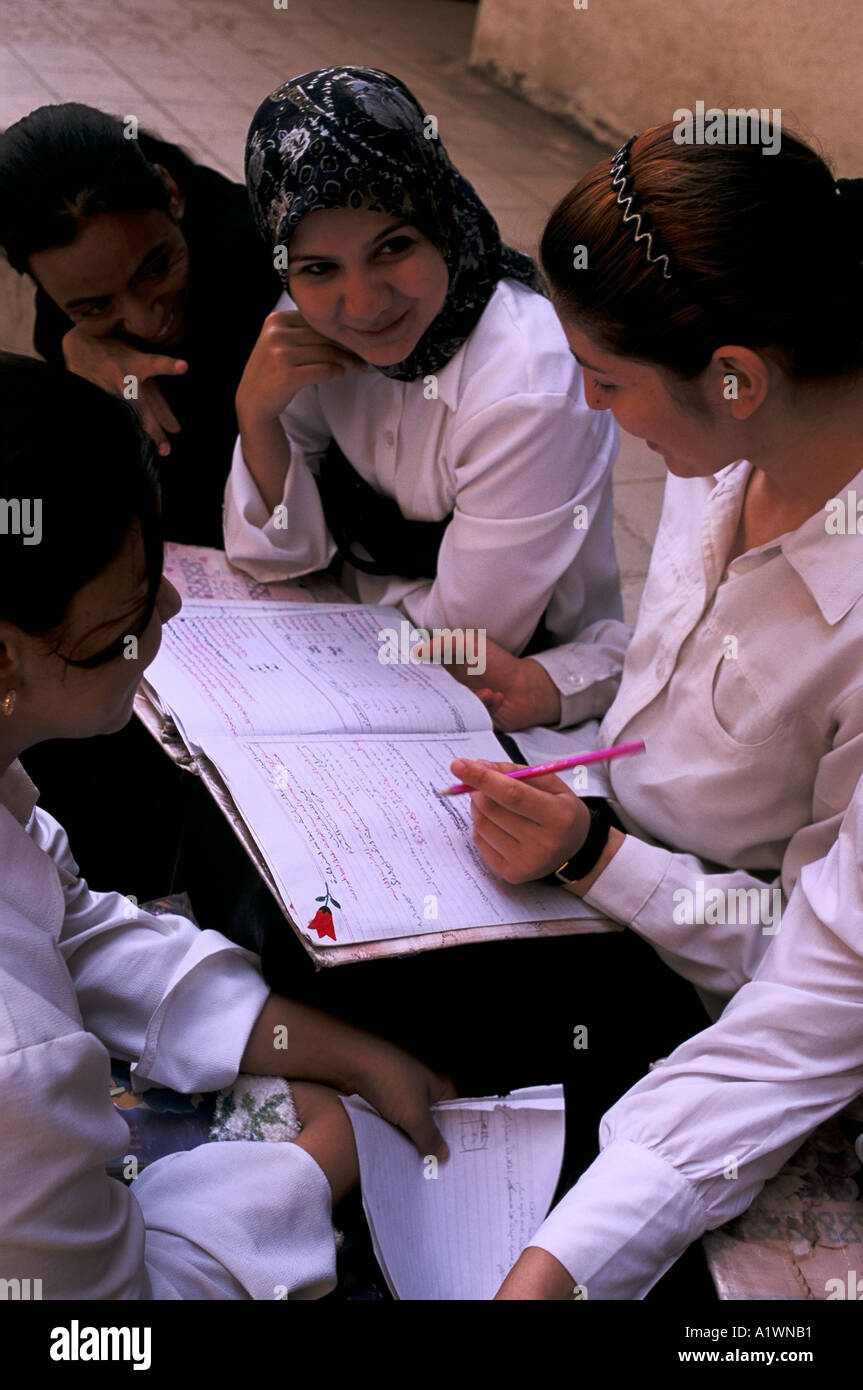 Baghdad Iraq June 2003. Girls and teacher check homework at Thewal Al ...