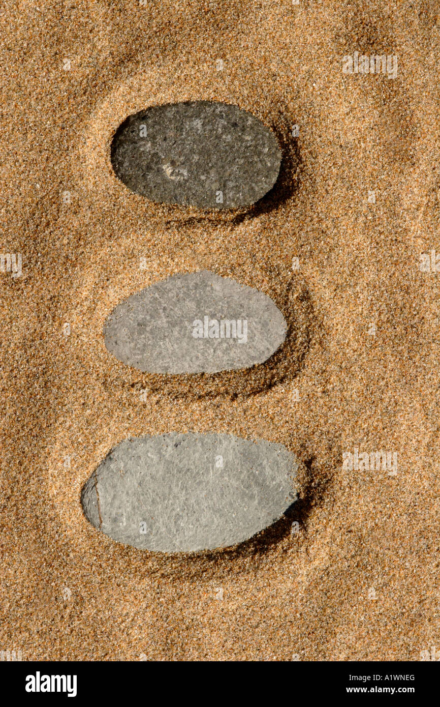 Pebbles in sand Stock Photo - Alamy