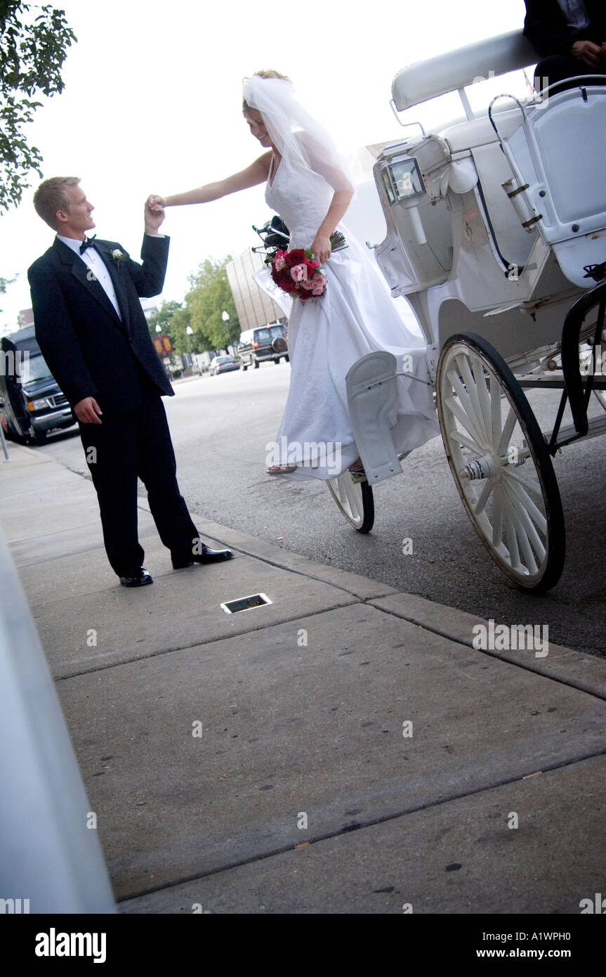 Bride and groom getting out of carriage Stock Photo - Alamy