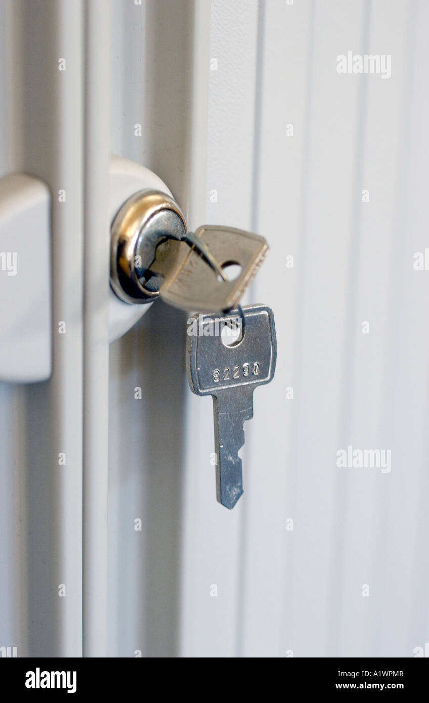 Two Keys In A Lock Stock Photo - Alamy