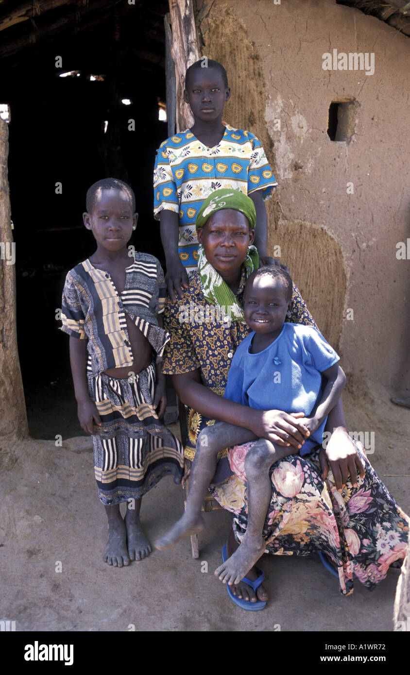 Uganda , Katakwi camp. HIV positive mother and children in front of ...