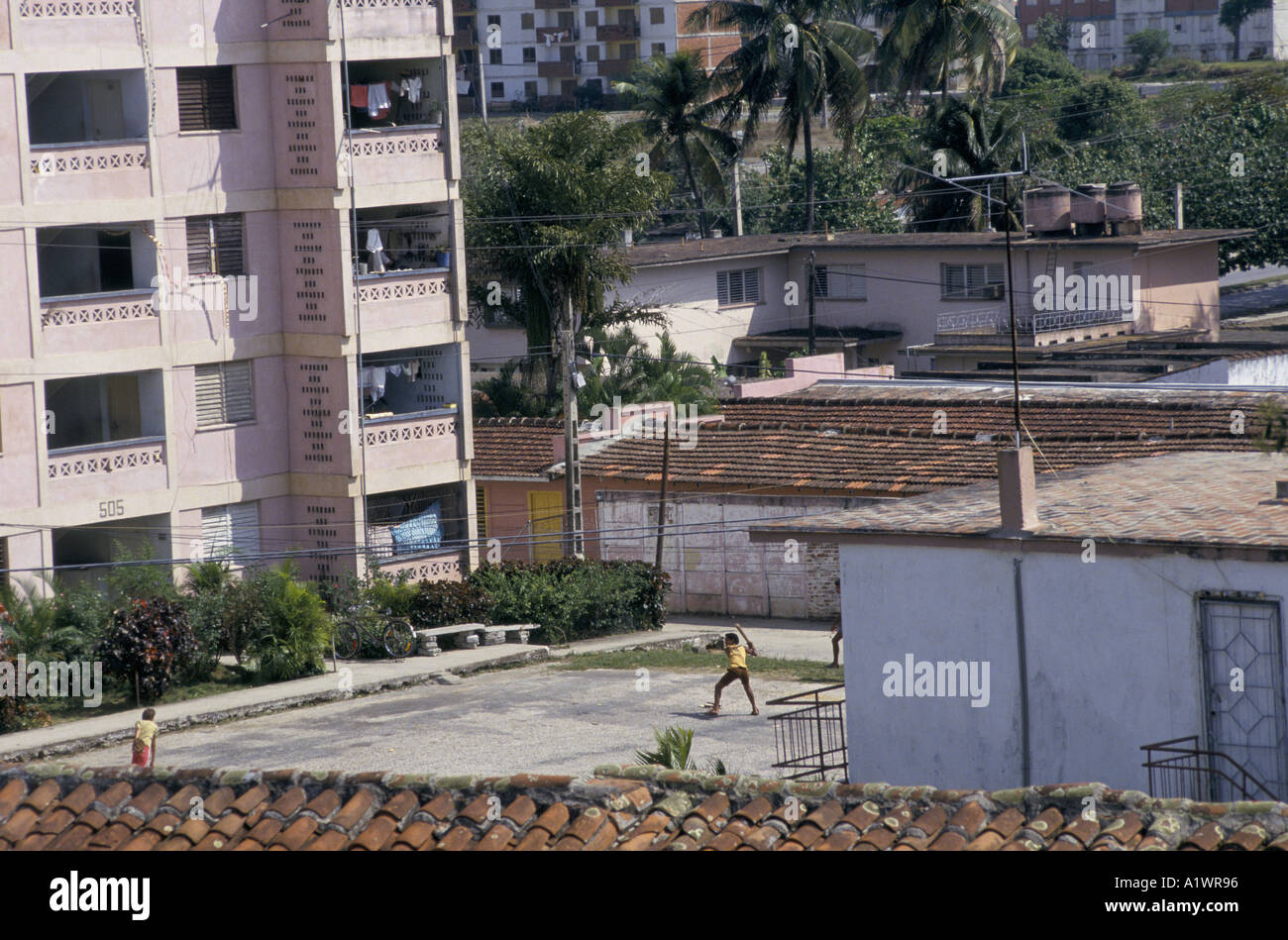 CUBA CHILDREN PLAYING BASEBALL ON STREETS BESIDE HOUSING BLOCKS 1993 ...