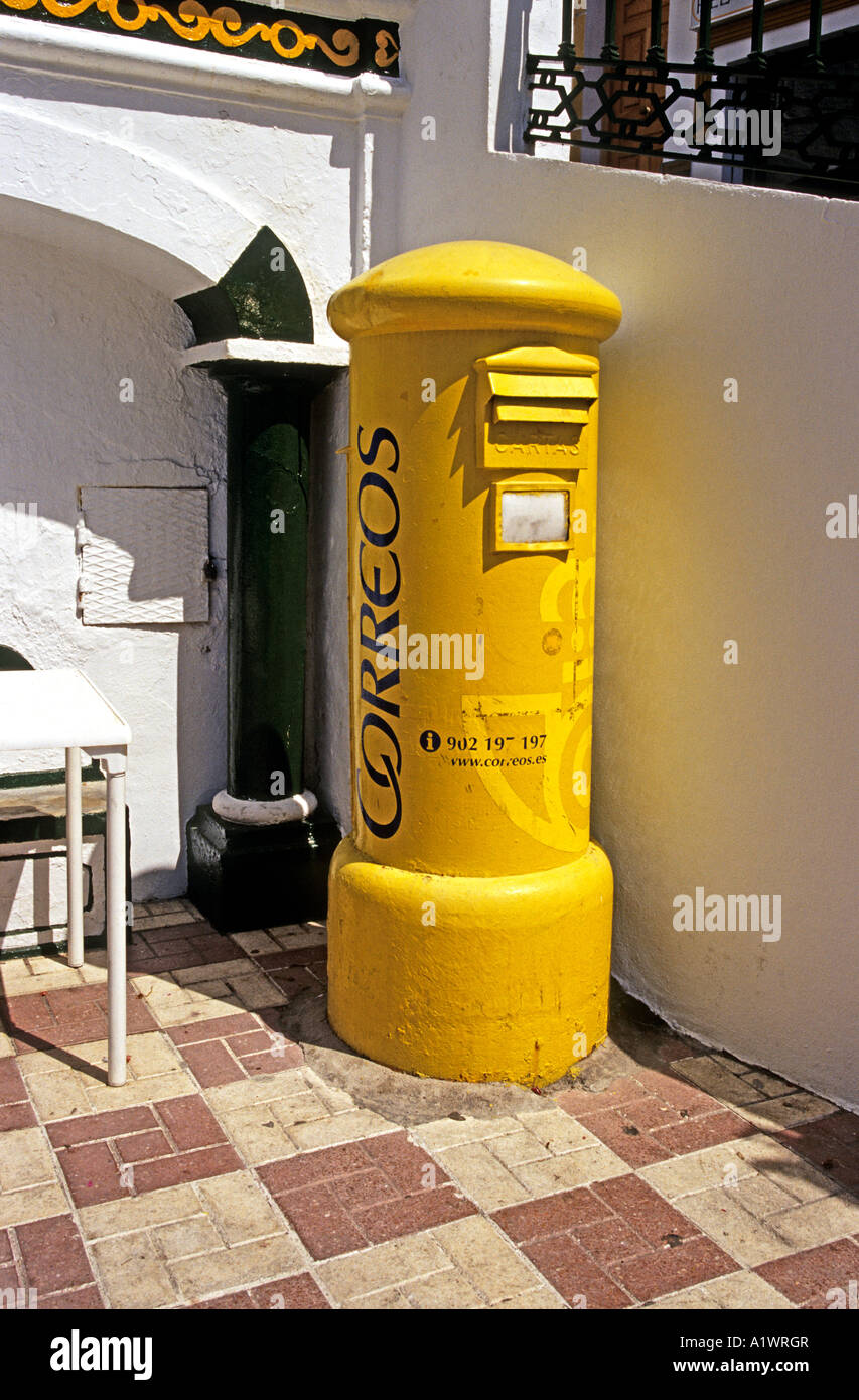 A yellow post or pillar box in the centre of Competa Andalusia Spain ...