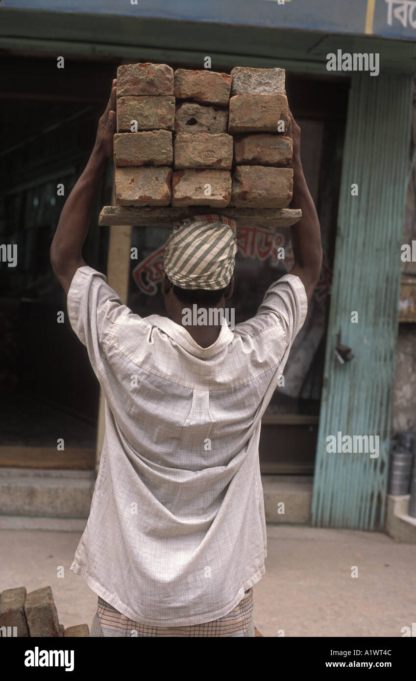 Man carrying load of bricks on his head Stock Photo - Alamy