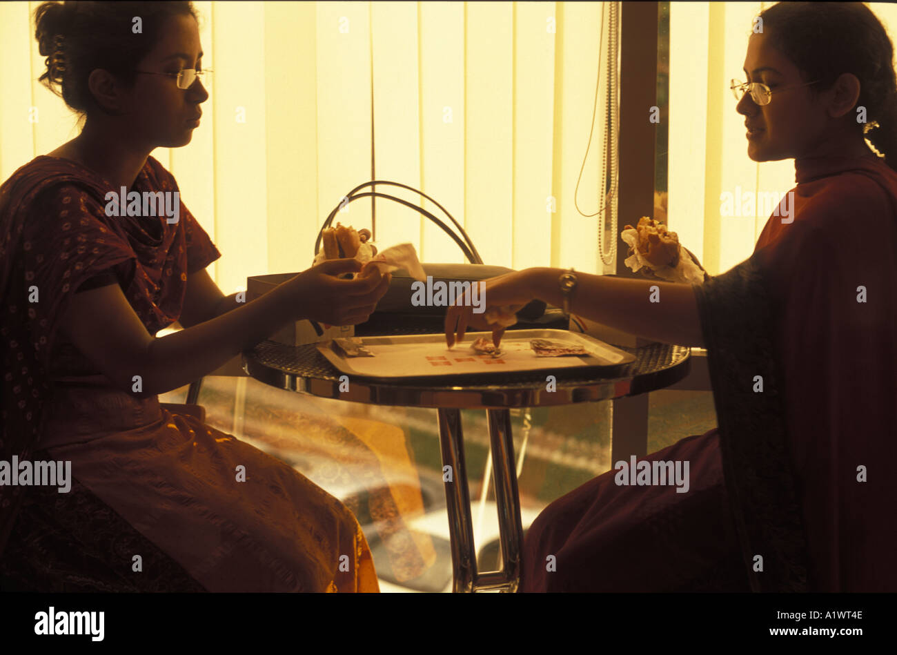Women eating in a fast food restaurant Stock Photo - Alamy