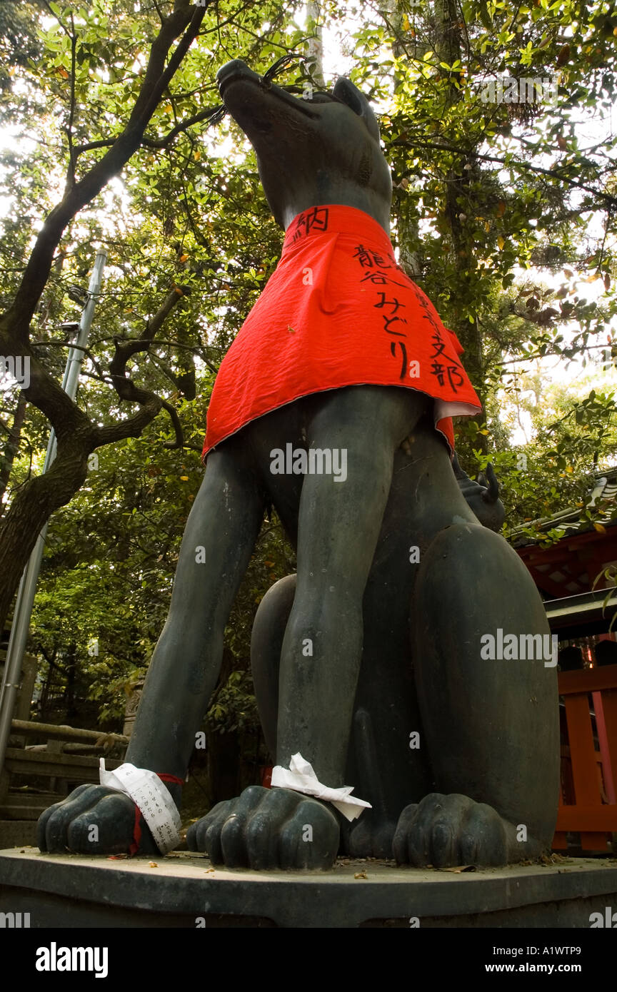 A statue of fox messenger or kitsune at Fushimi Inari Shrine in Kyoto ...