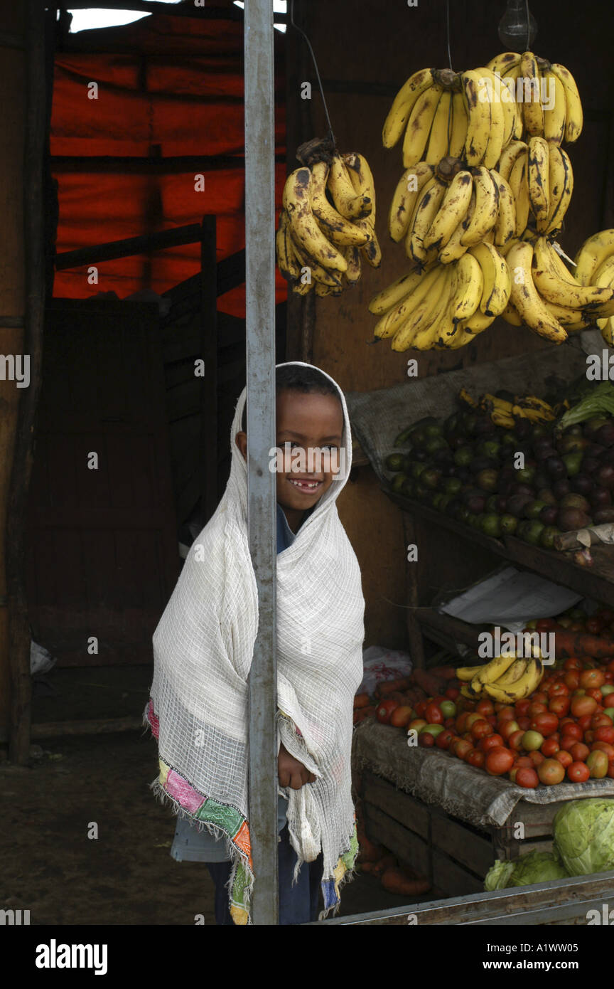 Young child selling fruit from a market stall Stock Photo - Alamy