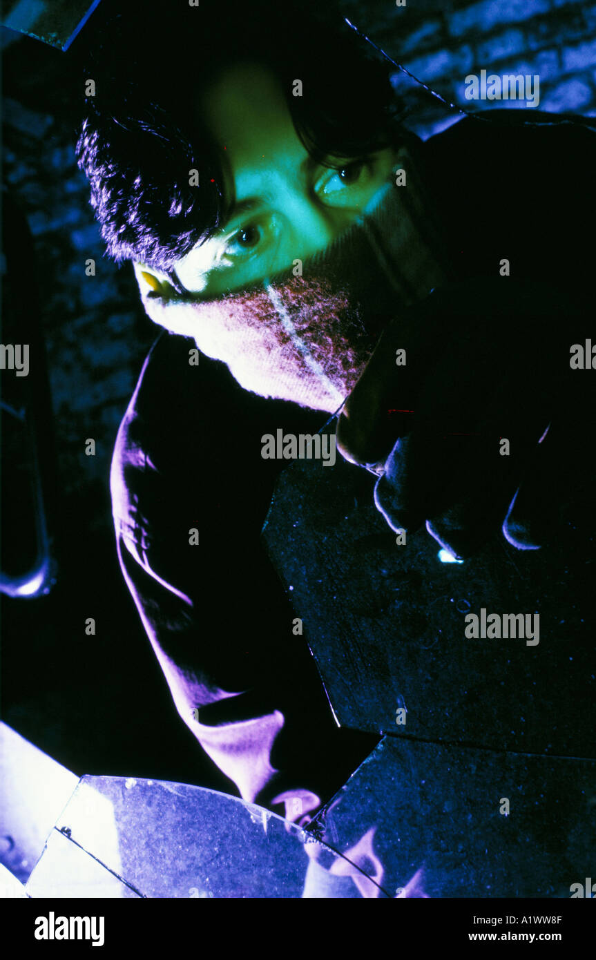 Man smashing window hi-res stock photography and images - Alamy