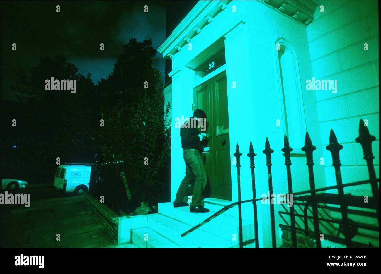 Thief breaking into a home by forcing the front door. Islington, London ...