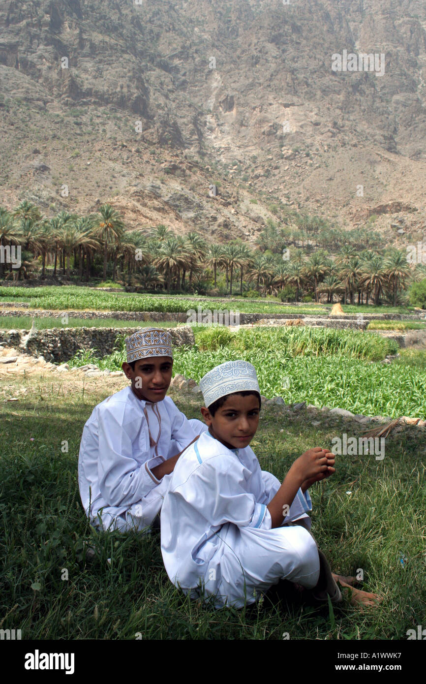 Boys resting in the shade, Bilad Sayt village Wadi Bani Hajar Mountains ...