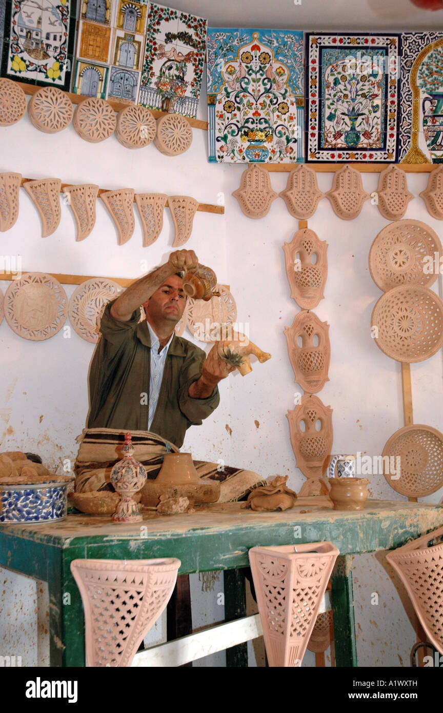 Man presenting his work in pottery workshop in Guellala town on Djerba ...