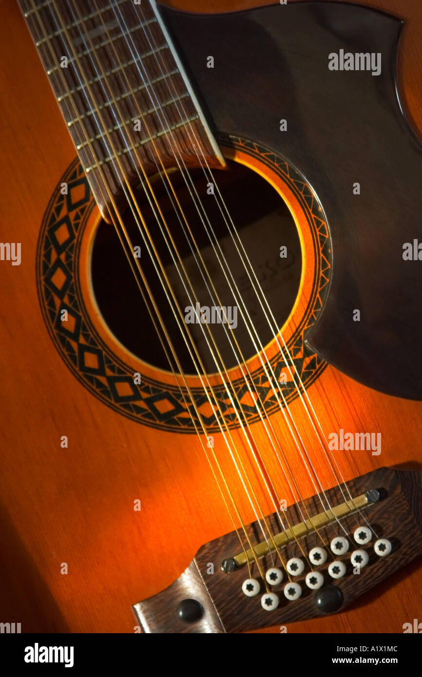 12 string guitar bridge and soundhole in sunlight Stock Photo - Alamy