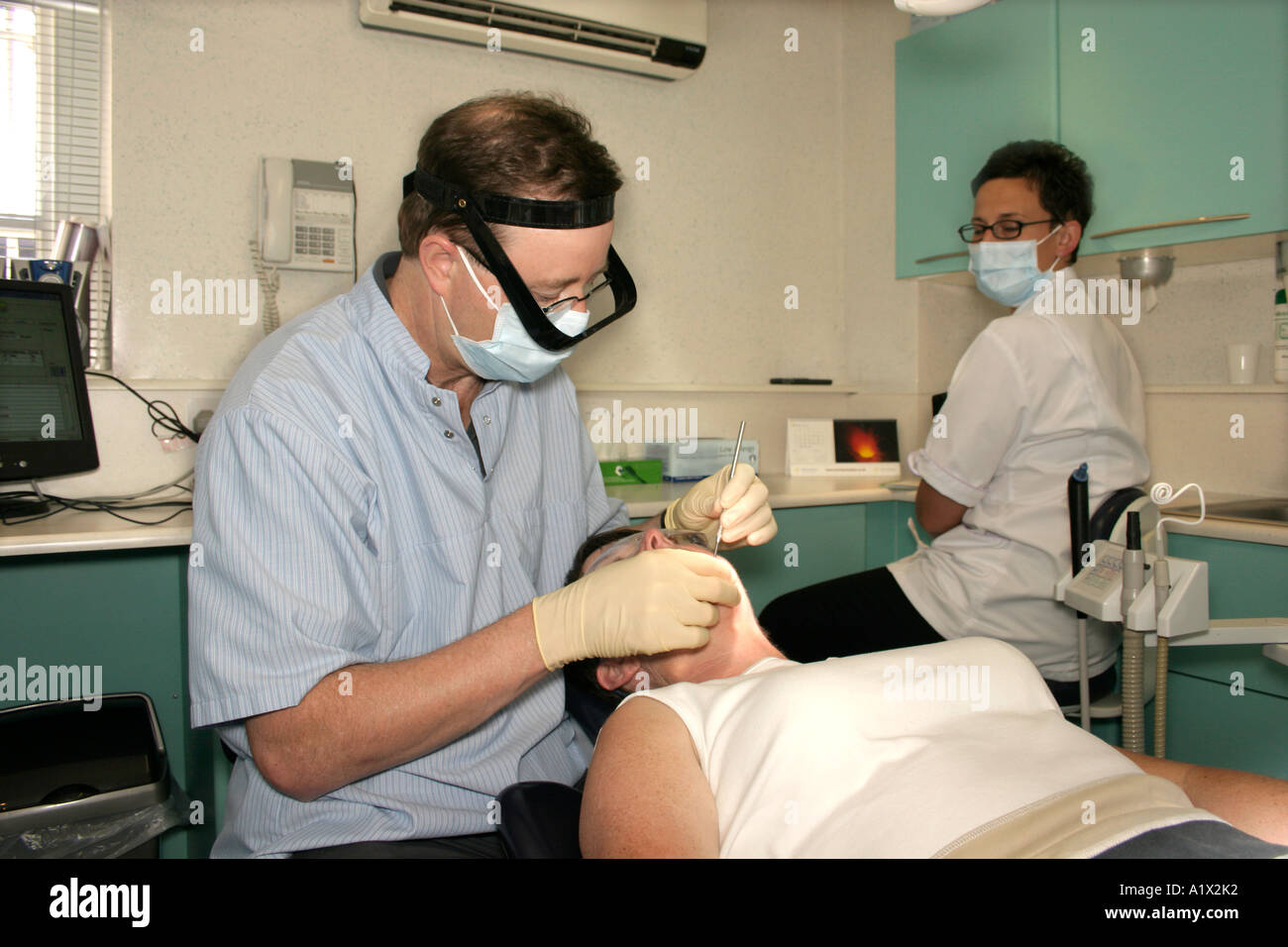 Dental Examination and dental nurse Stock Photo - Alamy
