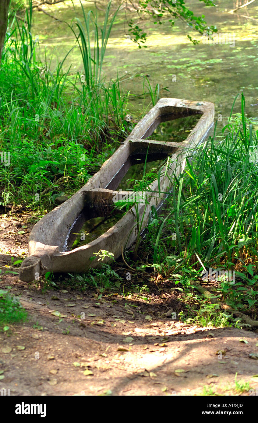 Carved wooden boat in a 2500 year old reconstructed ancient Slavic settlement. Biskupin Poland ...