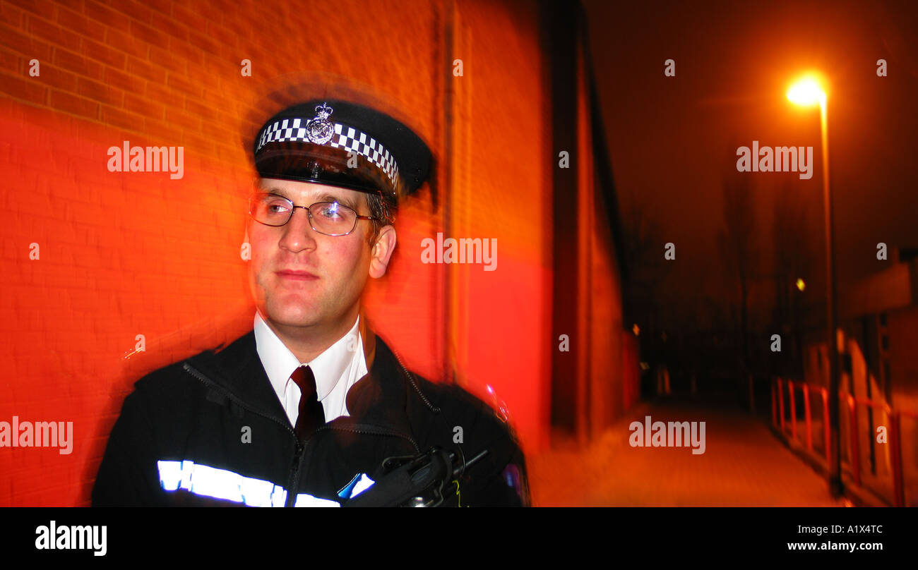 A police officer patroling the street at midnight in Toothill Swindon ...