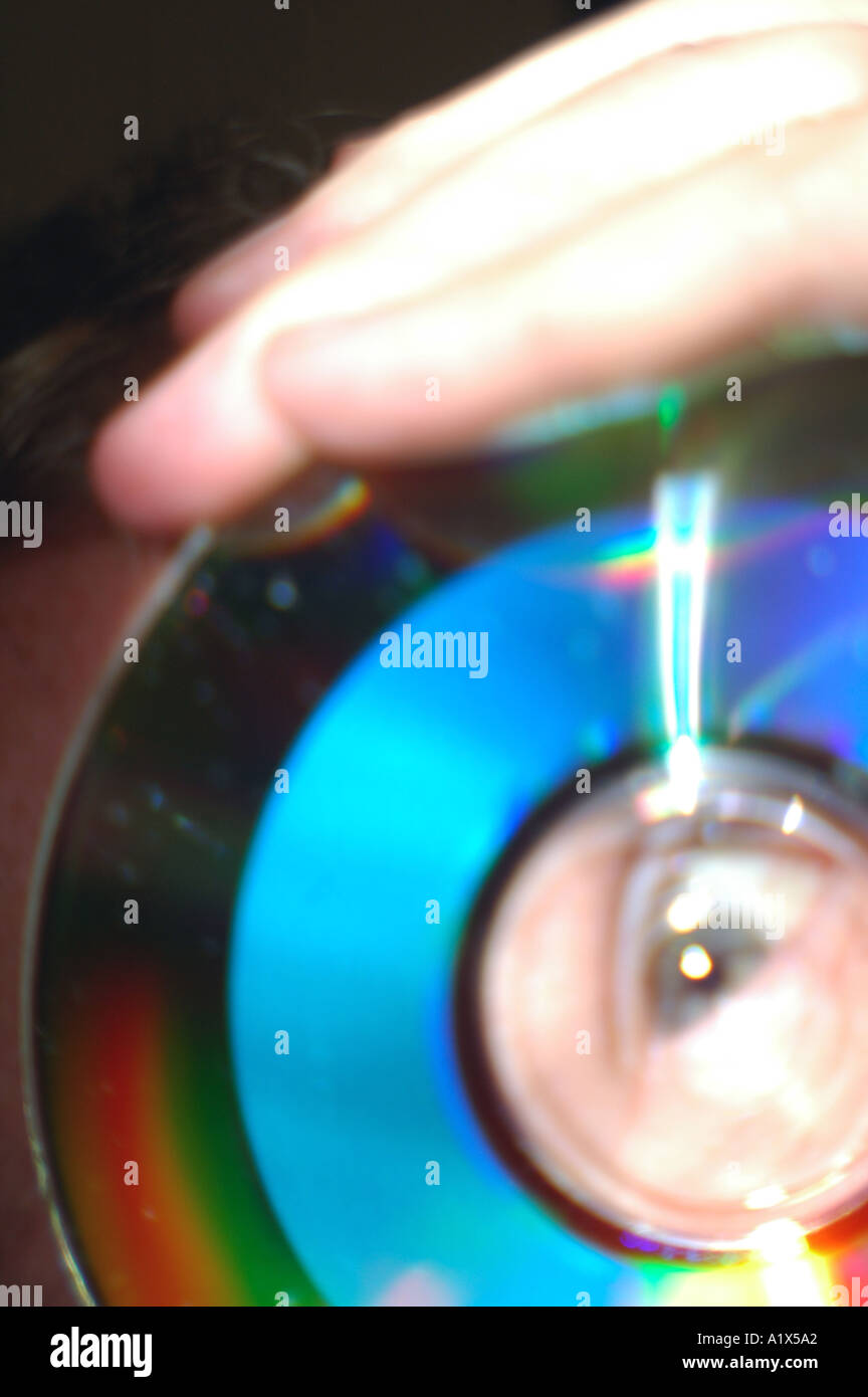 cd rom disc computer with saturated color eye looking through it ...