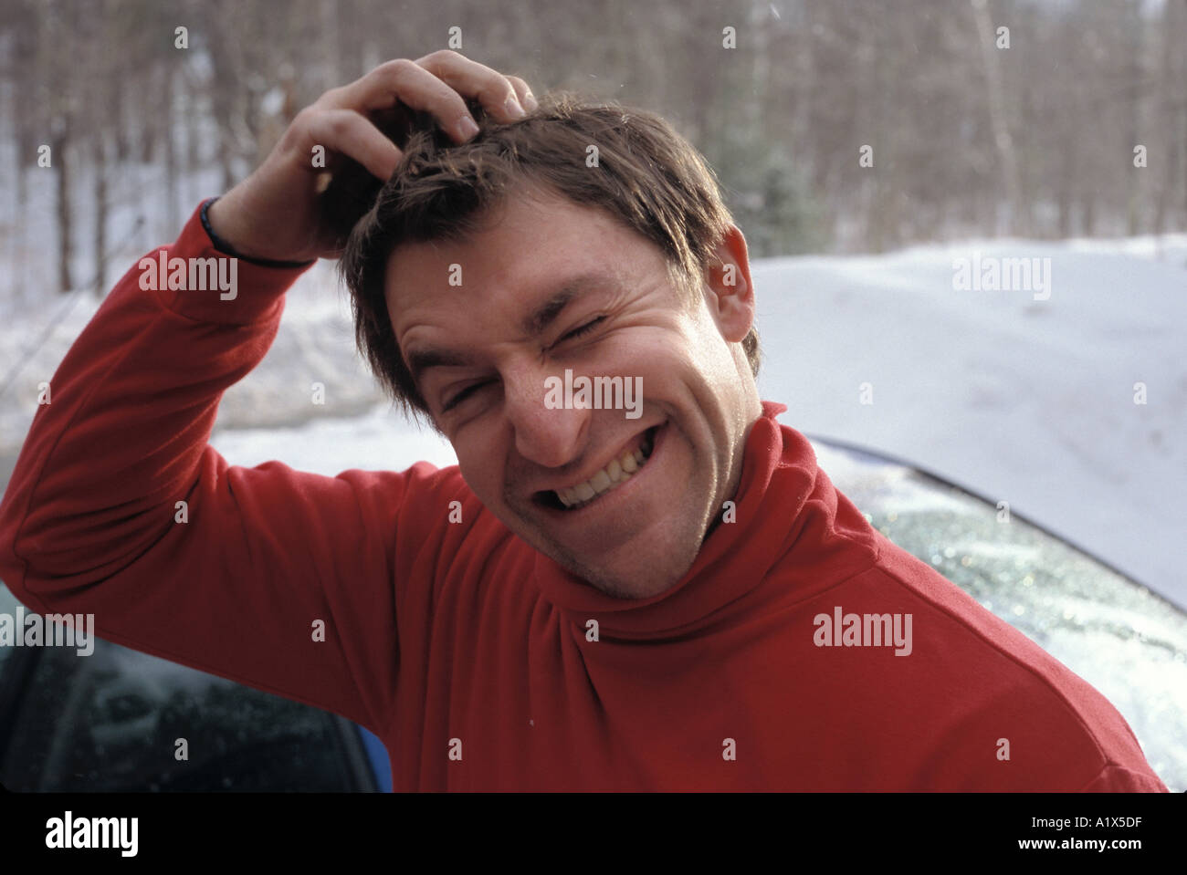 man scratching his head making funny face after long road trip Stock ...