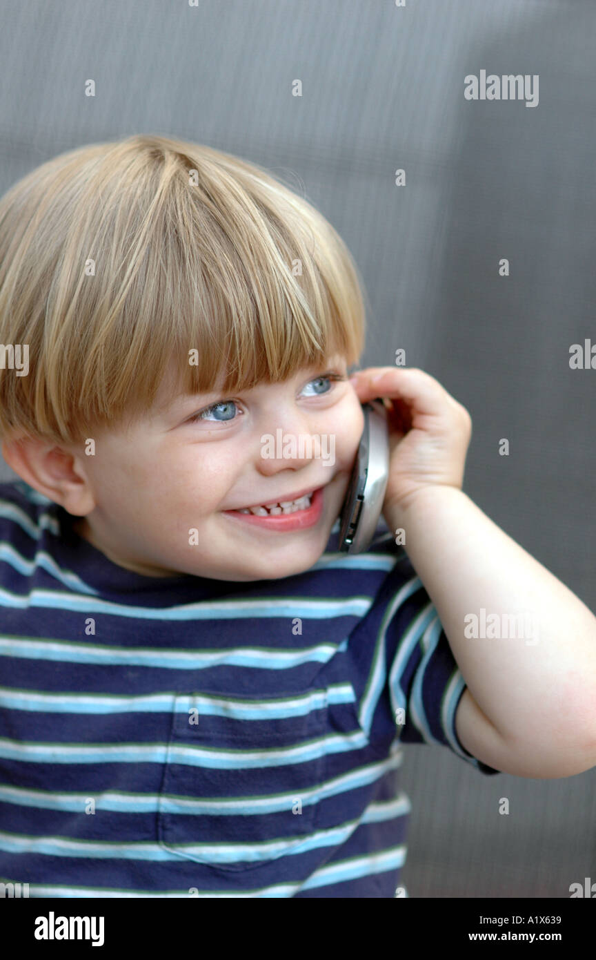 small boy child talking on cell phone communicating smiling Stock Photo ...