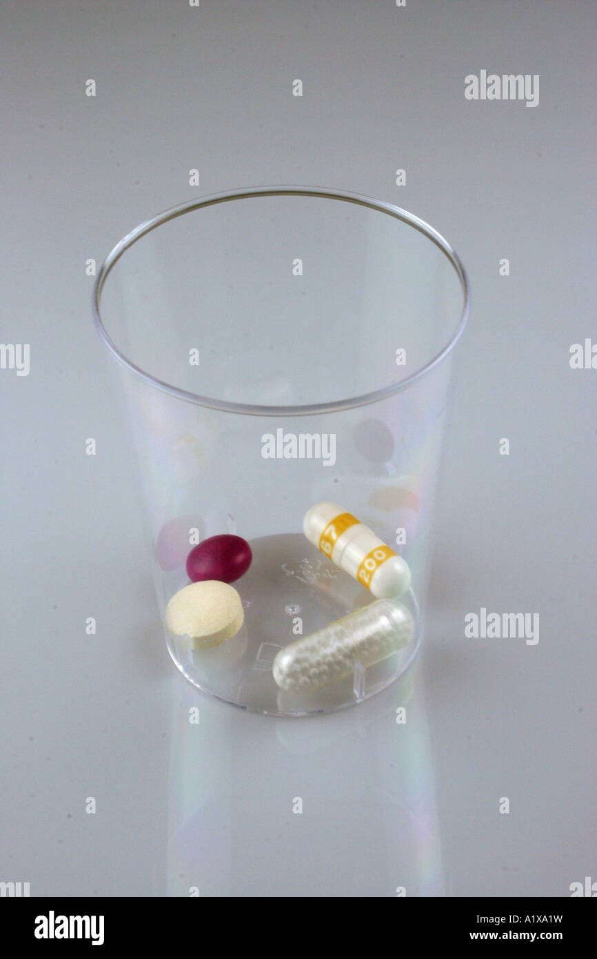cup with tablets Stock Photo - Alamy